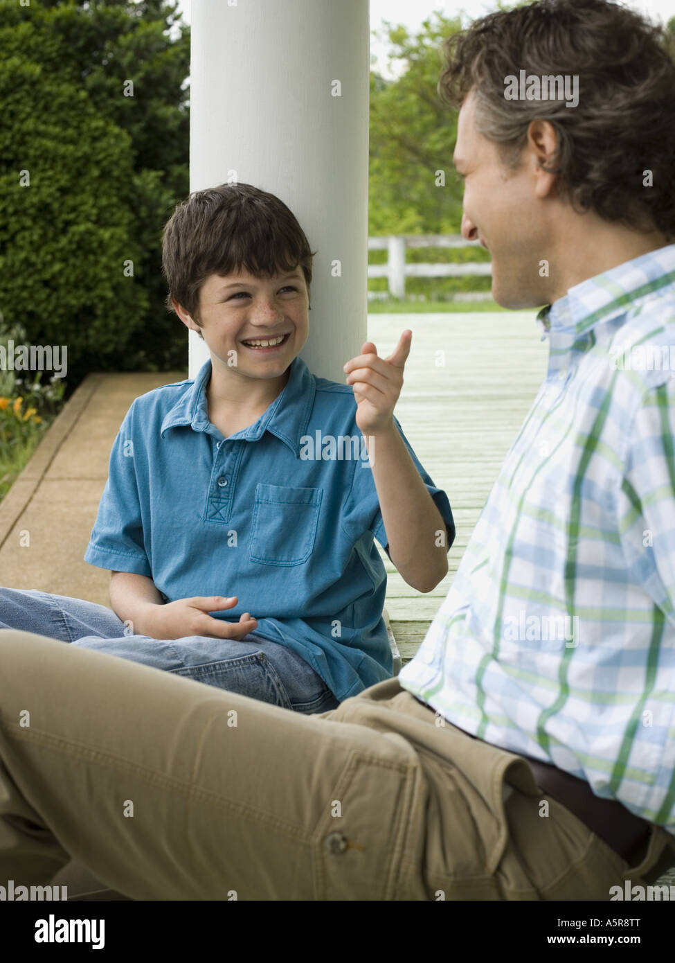 Close up of a boy and his father smiling Stock Photo - Alamy