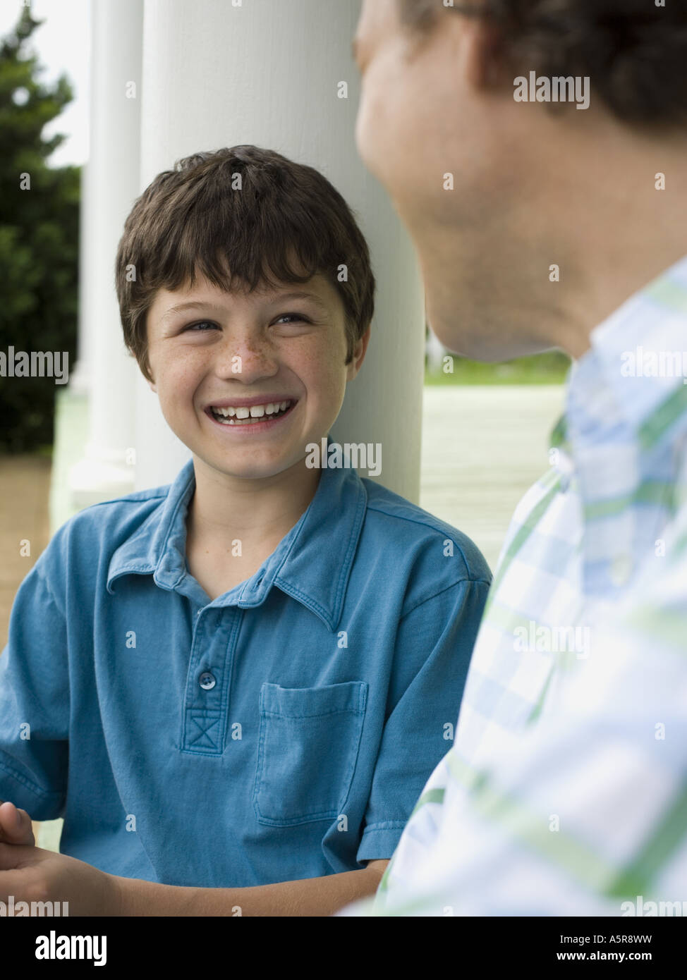 Close up of a boy and his father smiling Stock Photo - Alamy