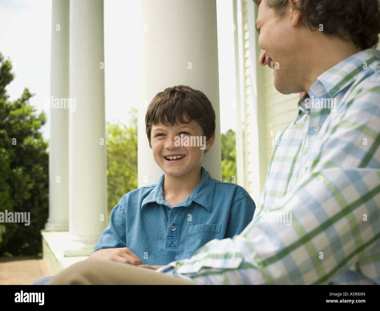 Close up of a boy and his father smiling Stock Photo - Alamy