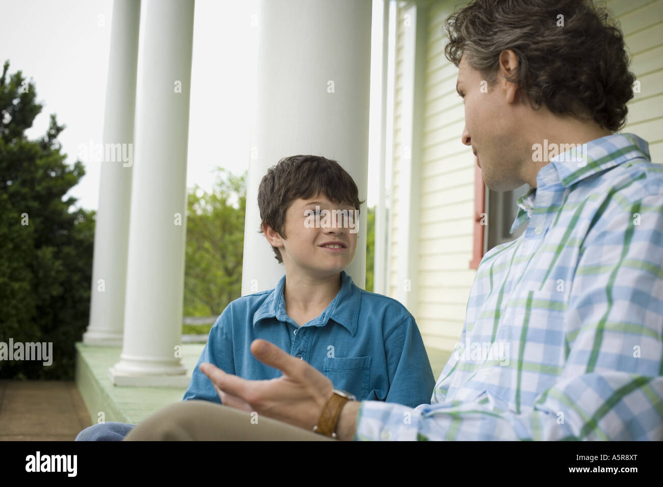 Close up of a boy and his father smiling Stock Photo - Alamy