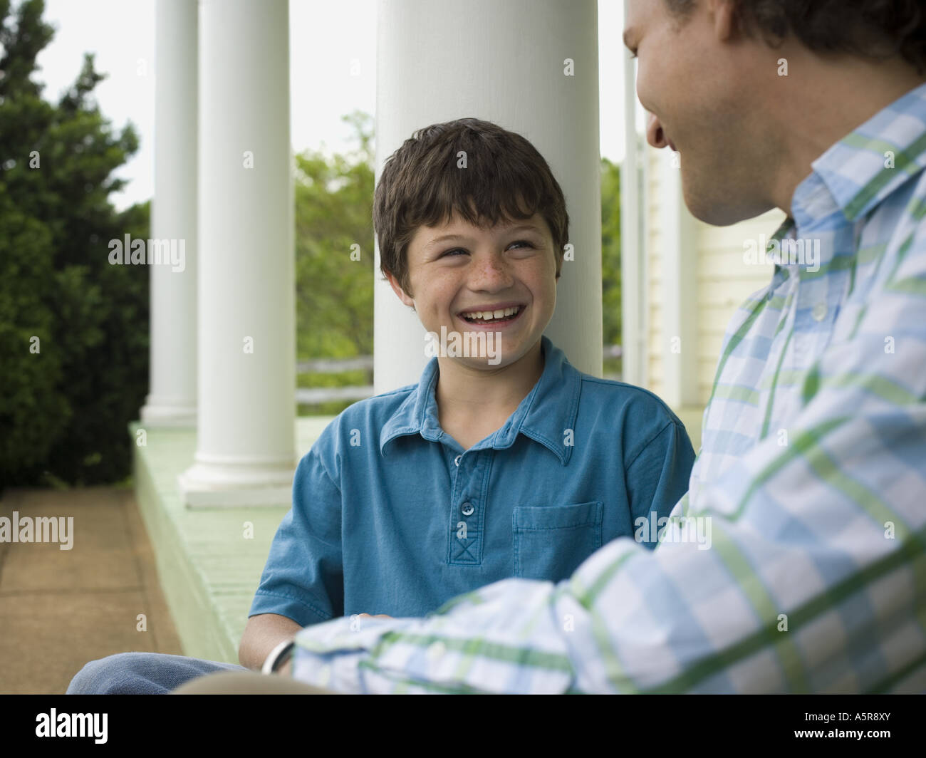 Close up of a boy and his father smiling Stock Photo - Alamy