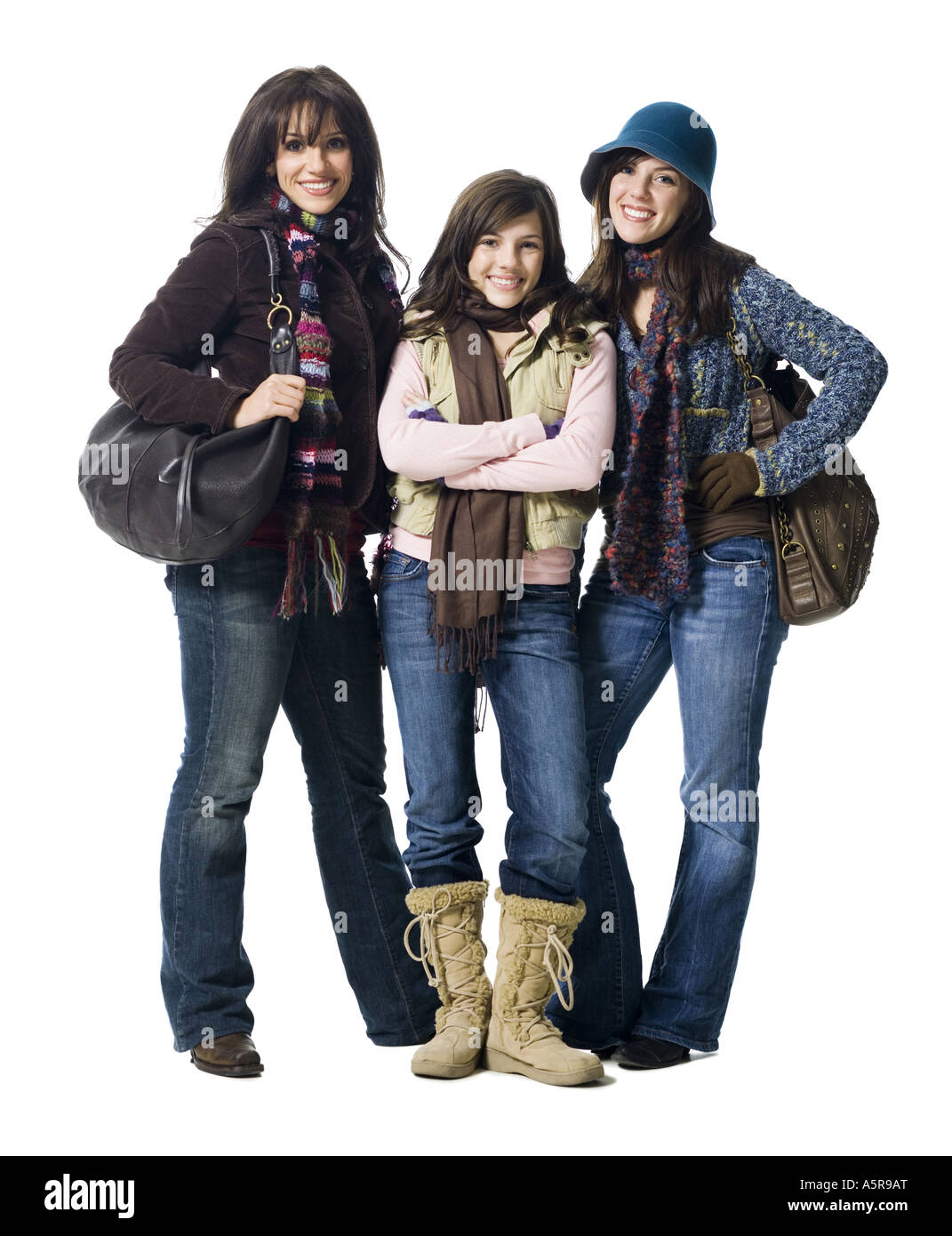 Three women in winter coats smiling Stock Photo - Alamy