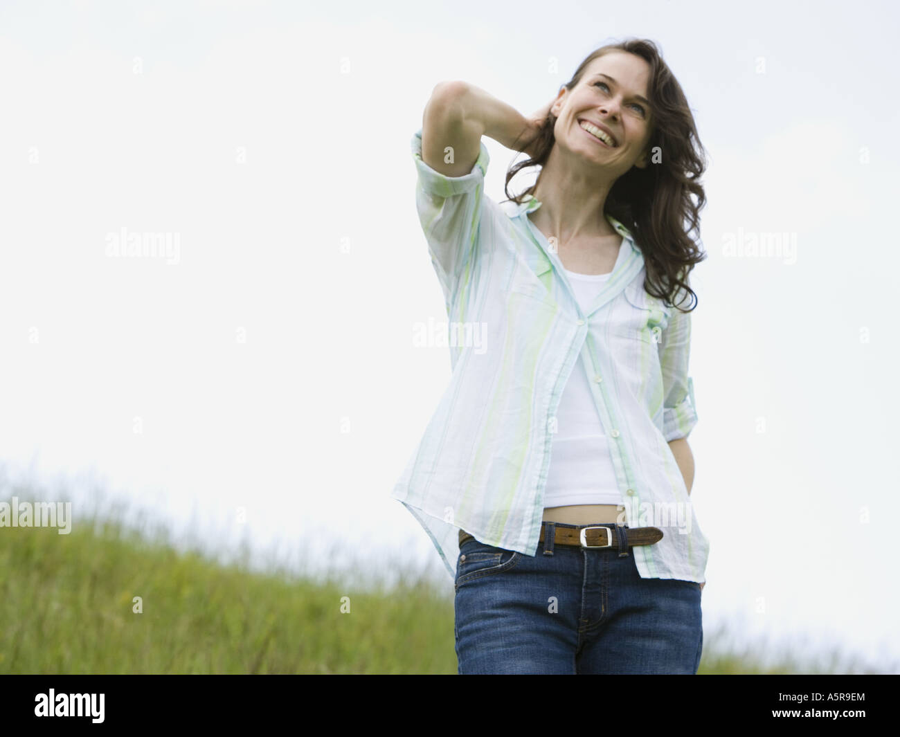 Low angle view of a woman laughing in a field Stock Photo - Alamy