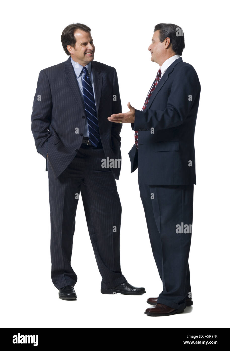 Two businessmen talking and smiling Stock Photo - Alamy