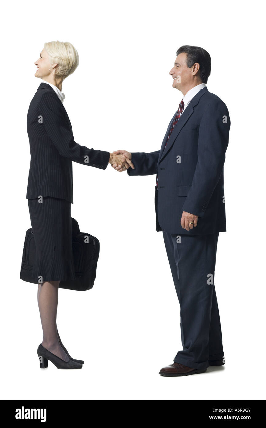 Businesswoman with head backwards shaking hands with businessman Stock ...