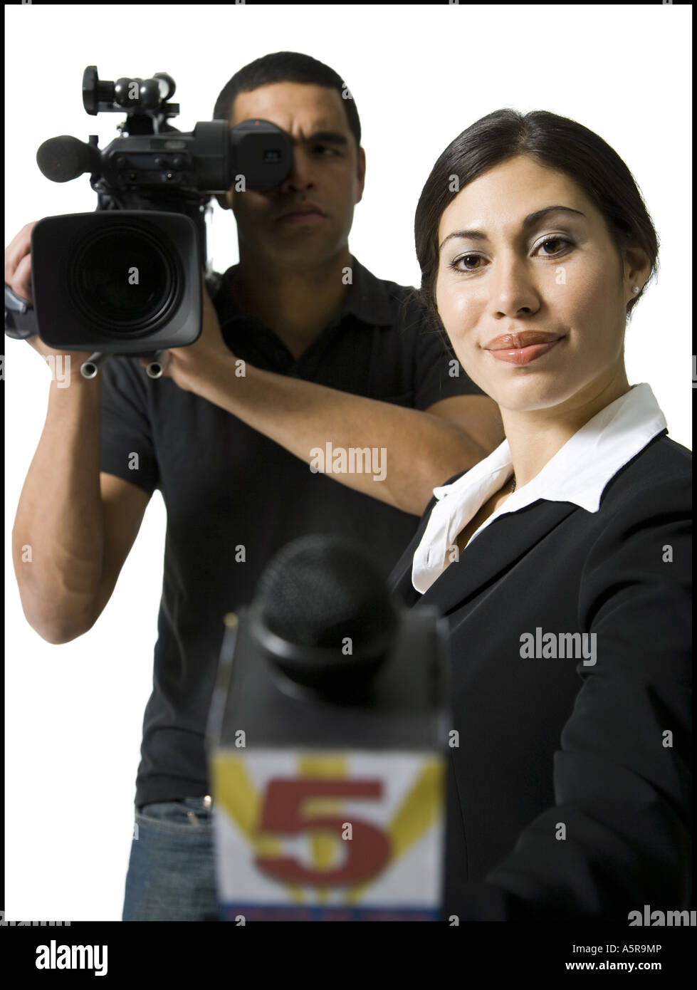 Female journalist with microphone and male videographer Stock Photo - Alamy