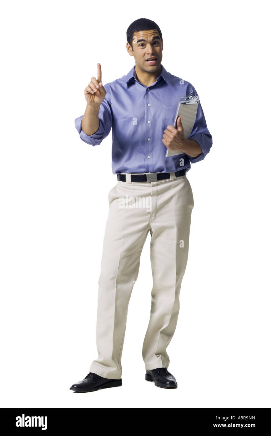 Man standing with clipboard pointing Stock Photo - Alamy