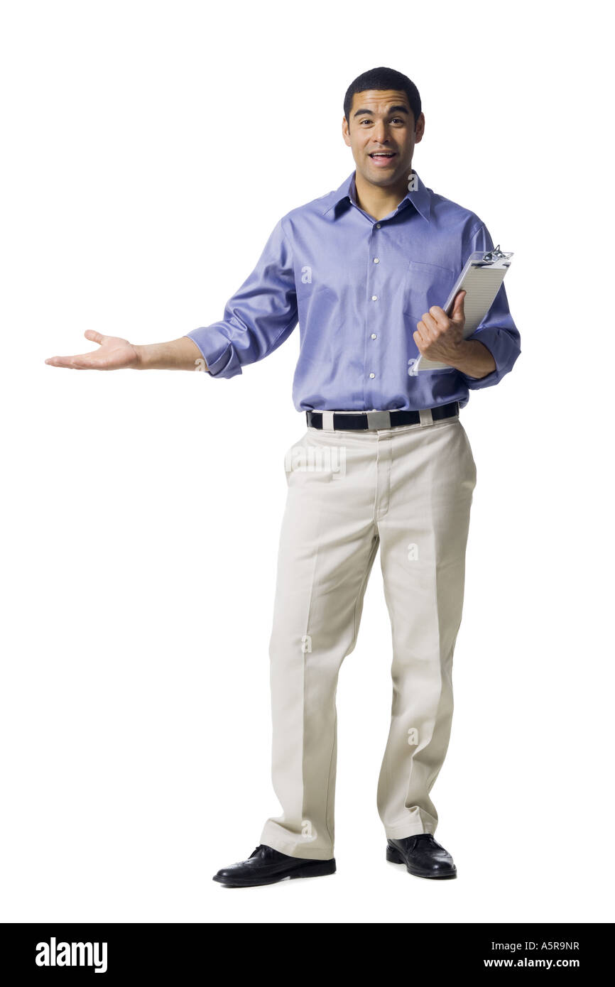 Man standing with clipboard pointing Stock Photo - Alamy