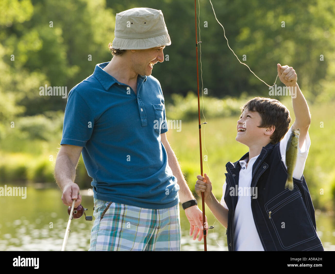 man and his son fishing Stock Photo - Alamy