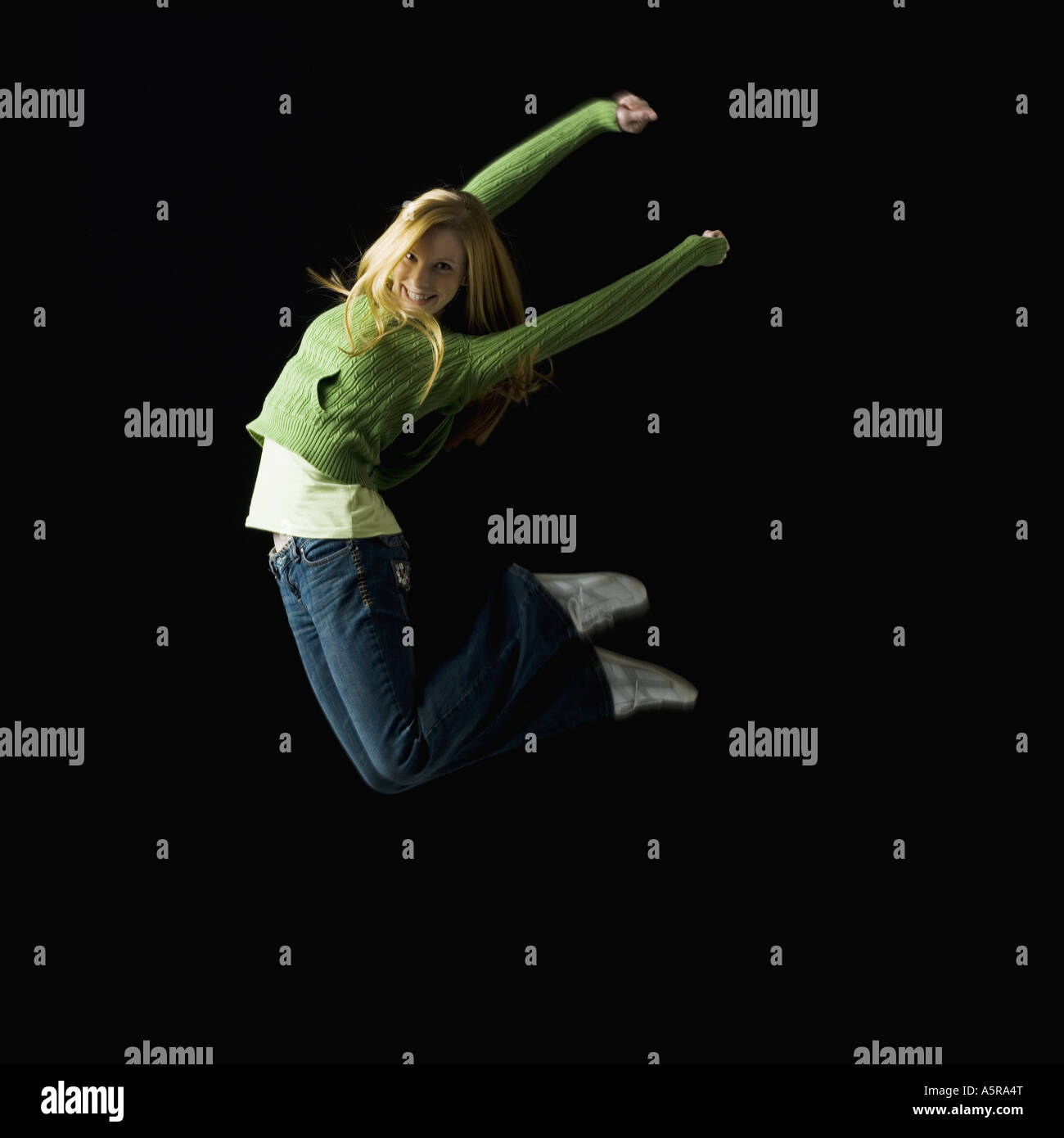 Girl leaping and smiling Stock Photo - Alamy