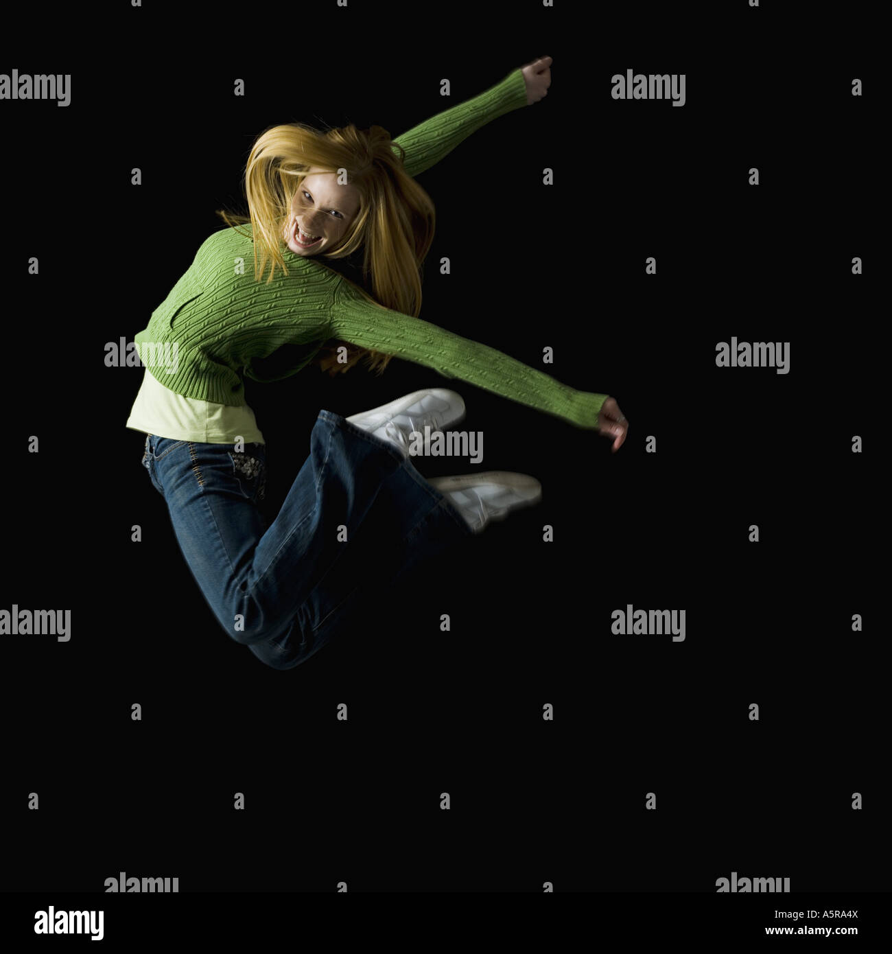 Girl leaping and smiling Stock Photo - Alamy