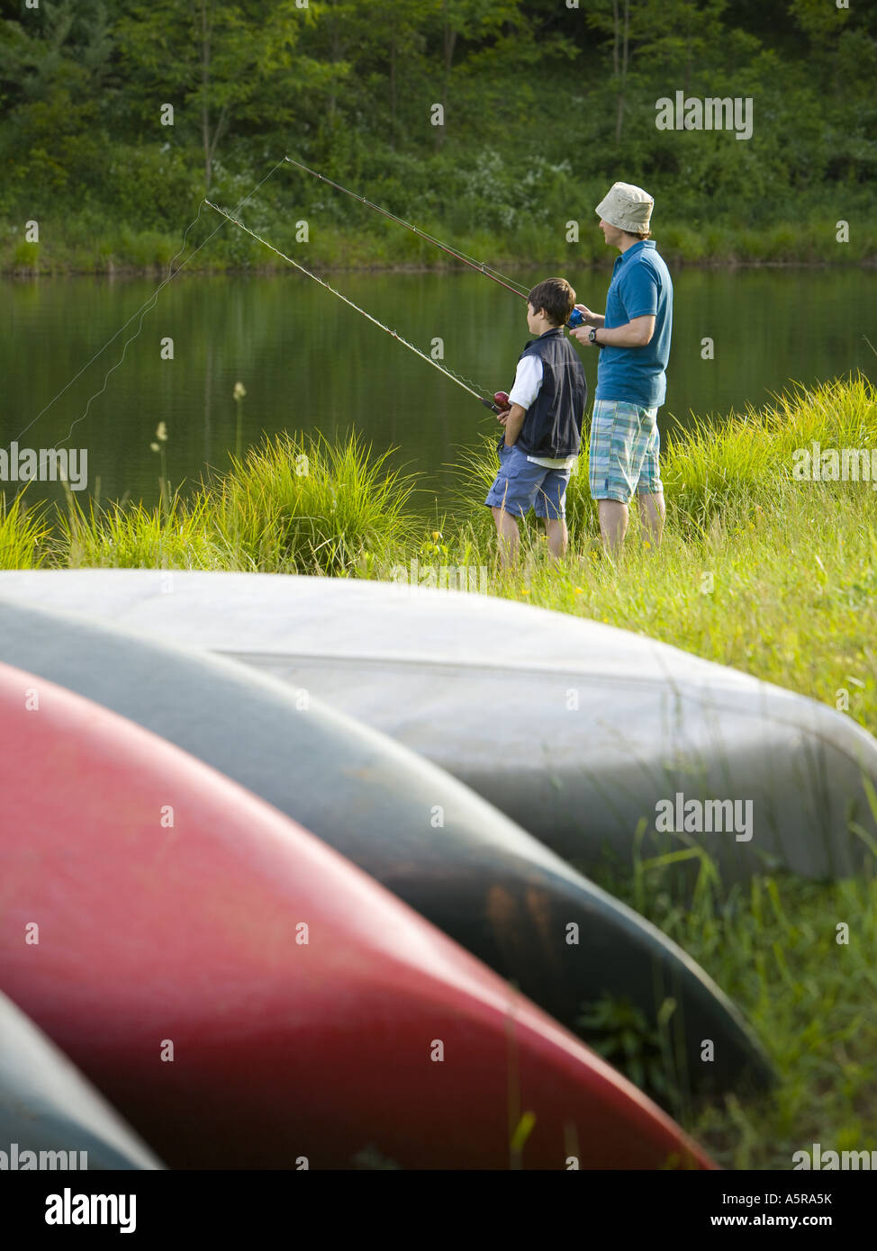 Profile of a man and his son fishing Stock Photo - Alamy