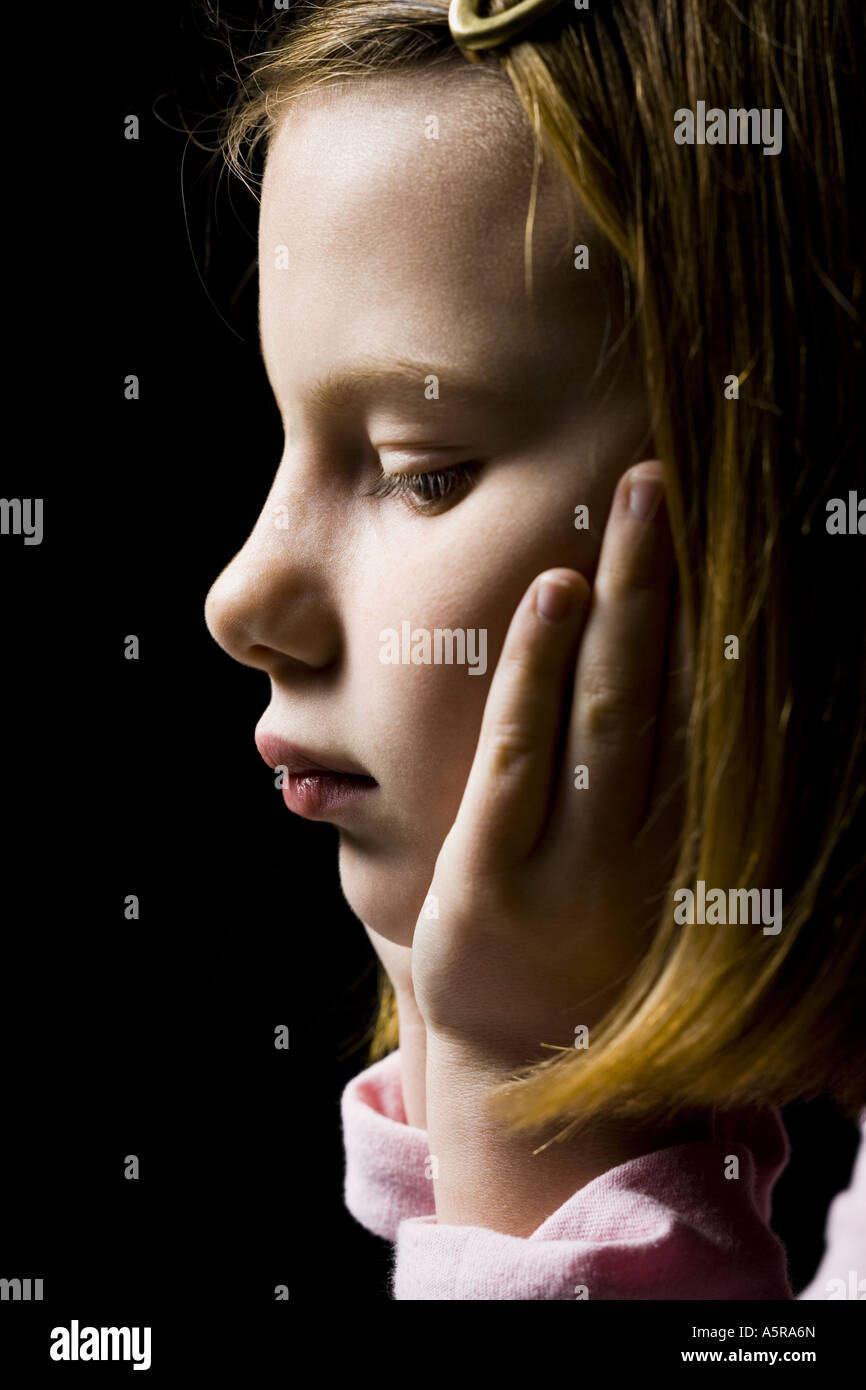 Side profile of young girl seated Stock Photo - Alamy
