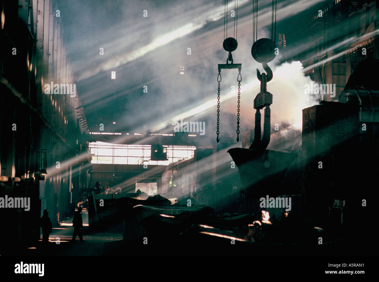 SMOKE SHAFTS OF SUNLIGHT FROM WINDOWS SILHOUETTING THE LIFTING ...