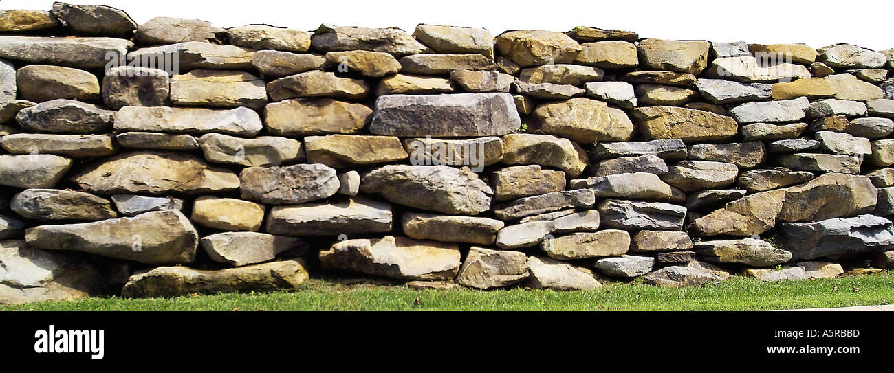 Stone rock wall landscaping fence Stock Photo - Alamy