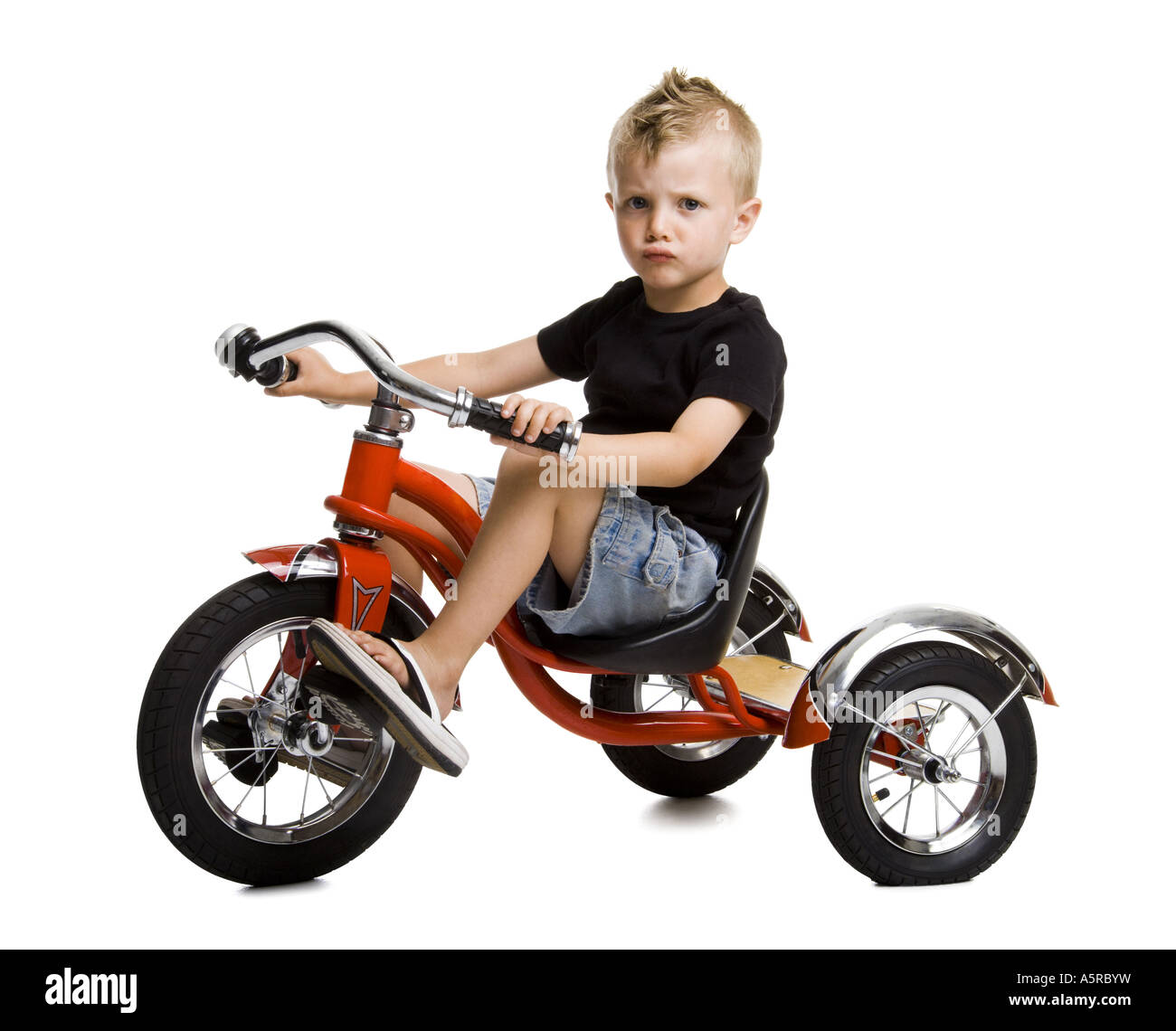 Boy on tricycle Stock Photo - Alamy