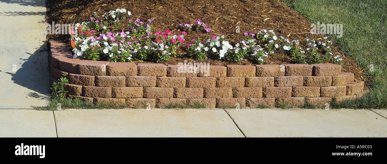 Edge brick wall with flowers Stock Photo - Alamy
