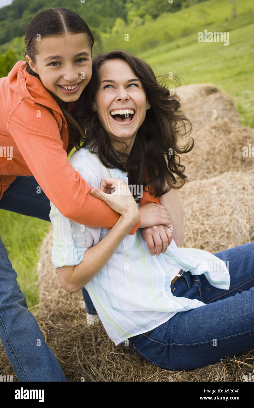 Portrait of a girl hugging her mother from behind Stock Photo - Alamy