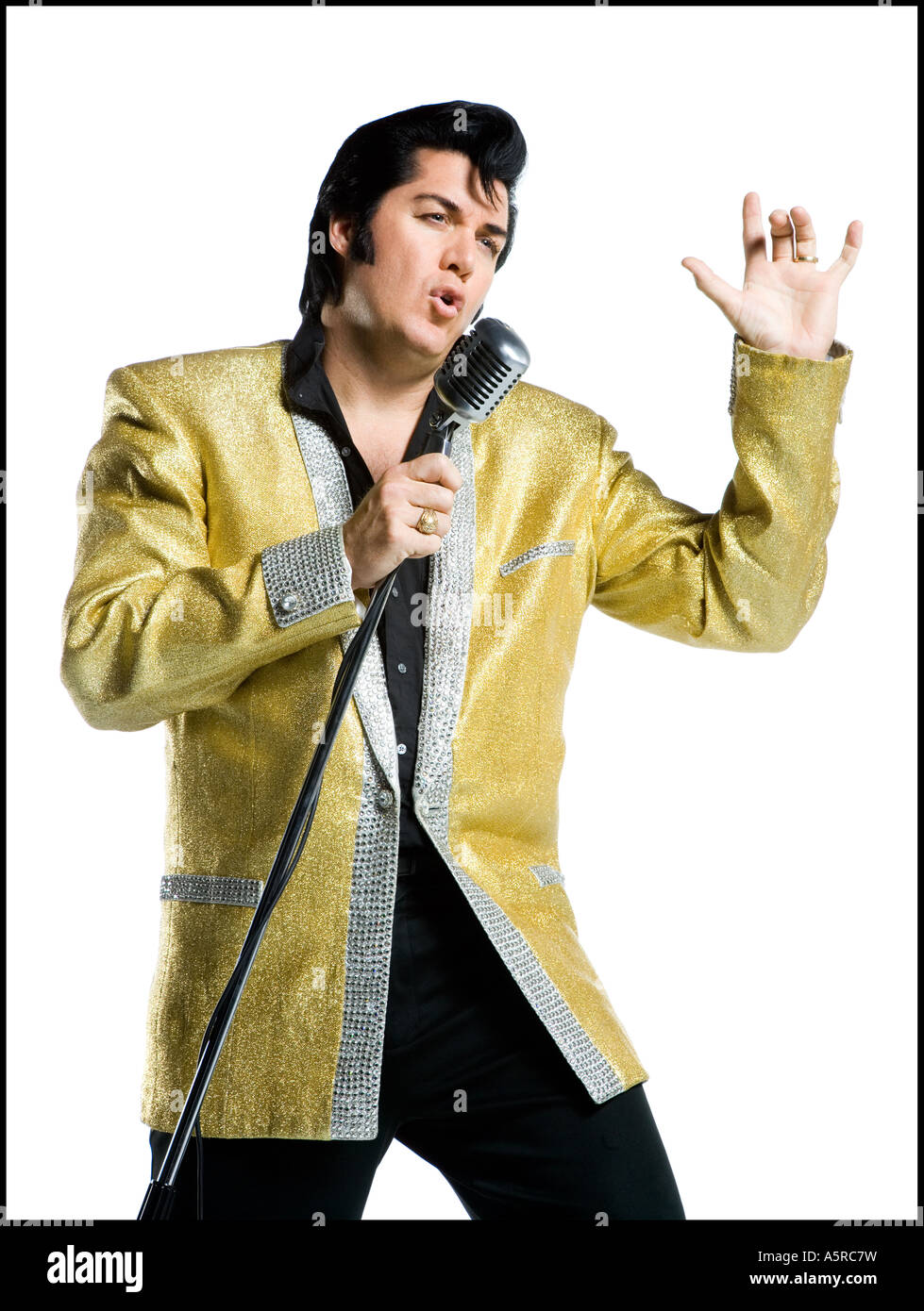 Close up of an Elvis impersonator singing into a microphone Stock Photo ...