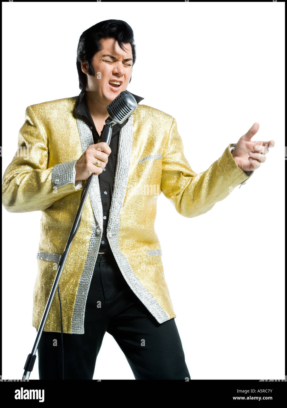Close up of an Elvis impersonator singing into a microphone Stock Photo ...