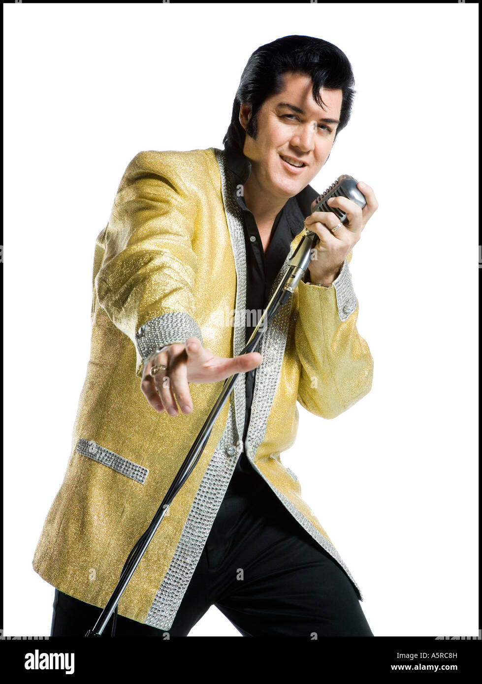 Portrait of an Elvis impersonator singing into a microphone Stock Photo ...