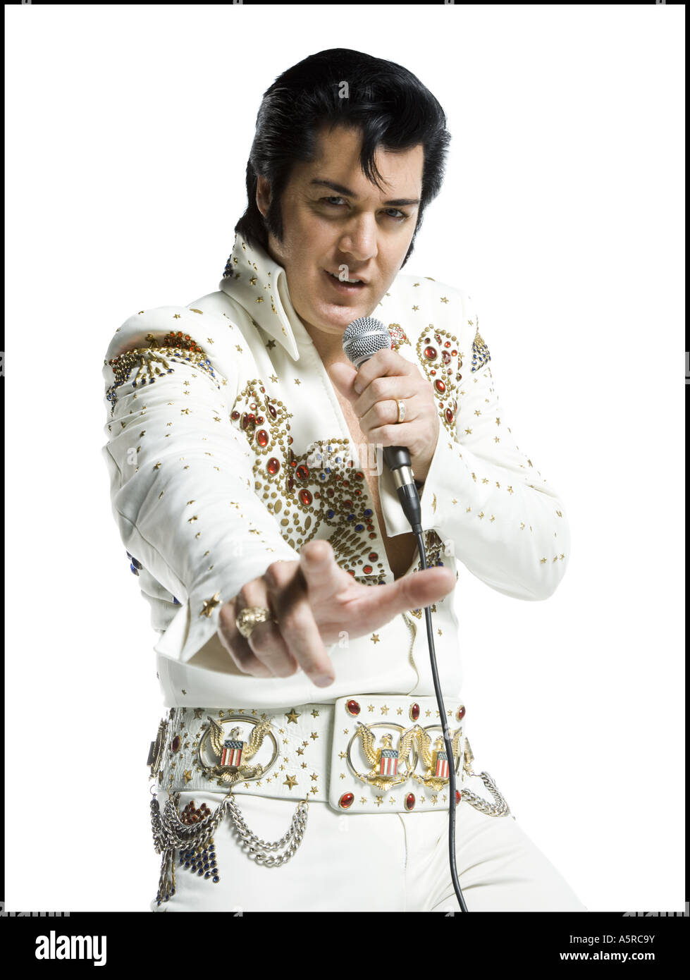 Portrait of an Elvis impersonator singing into a microphone Stock Photo ...