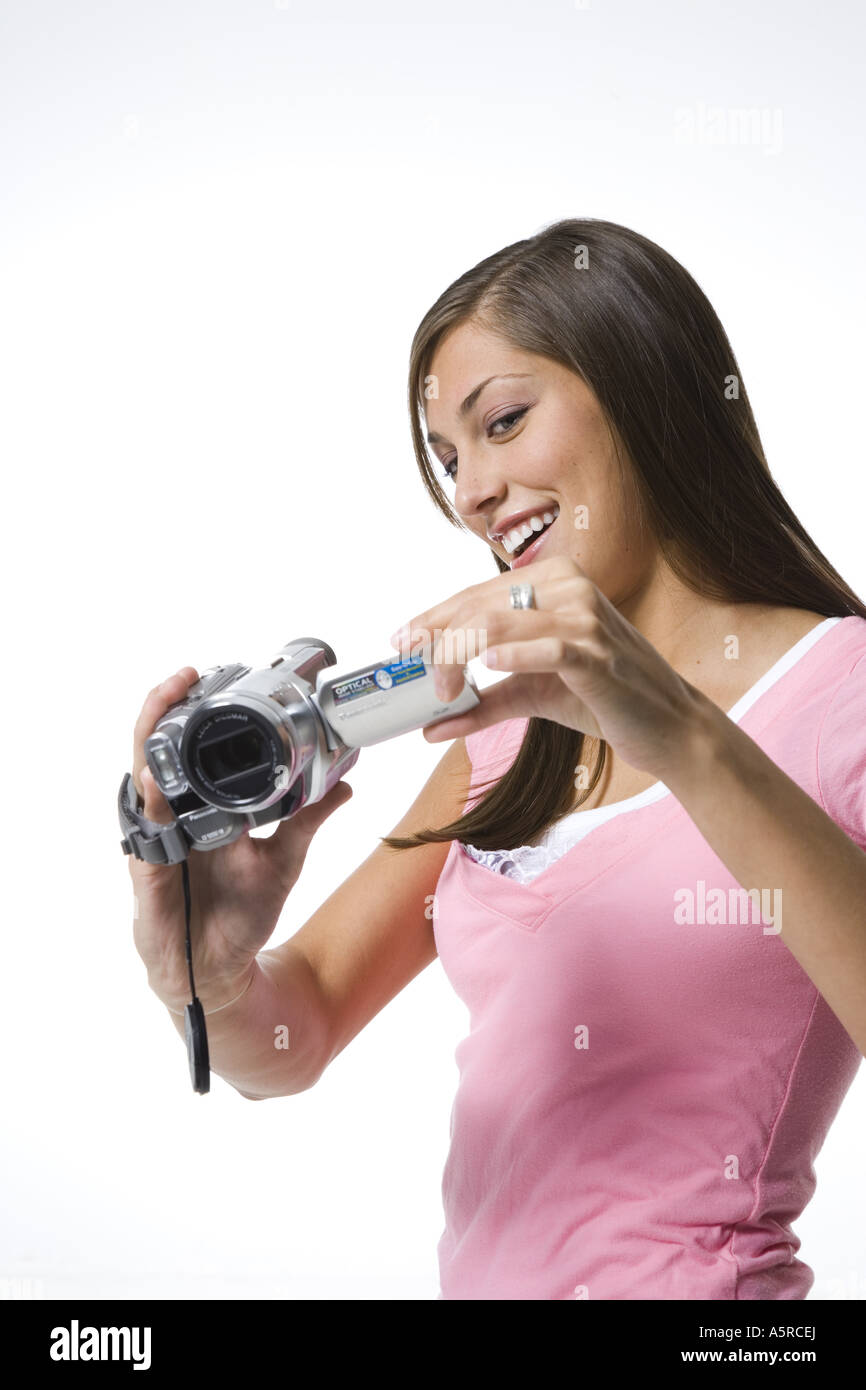 A young woman filming with a home video camera Stock Photo - Alamy