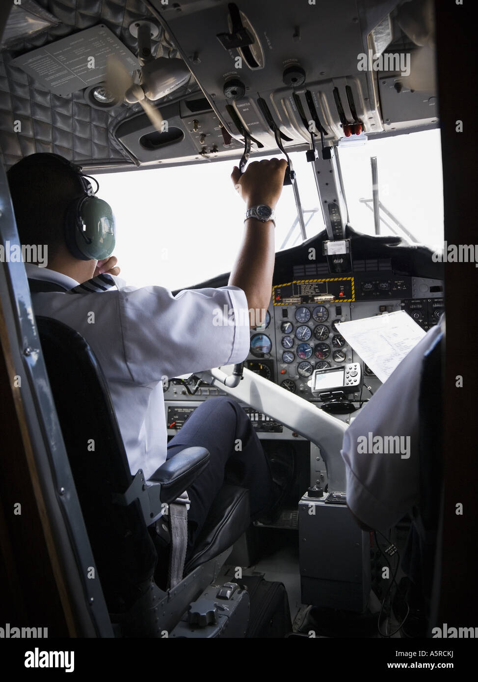 Rear view of two pilots sitting in airplane cockpit Stock Photo - Alamy