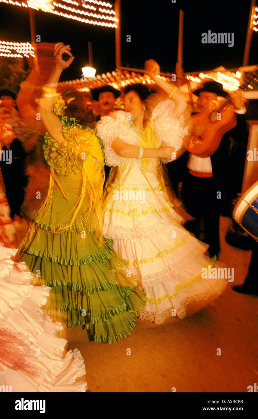 WOMEN WEARING TRADITIONAL FLAMENCO DRESSES DANCING AT SEVILLE FAIR ...