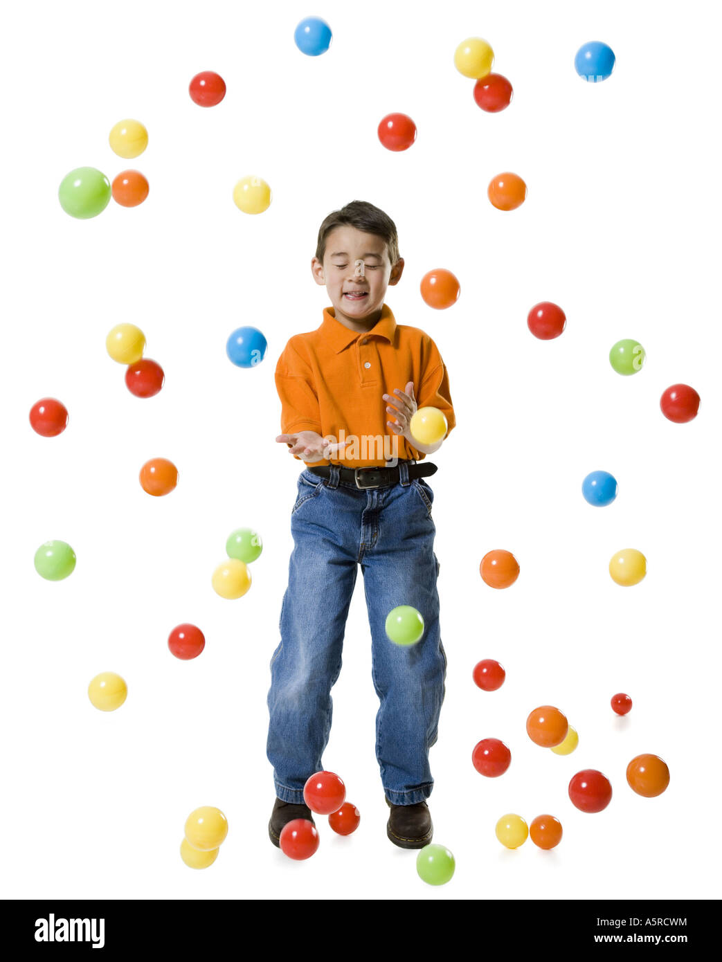 Boy playing with colored balls Stock Photo - Alamy