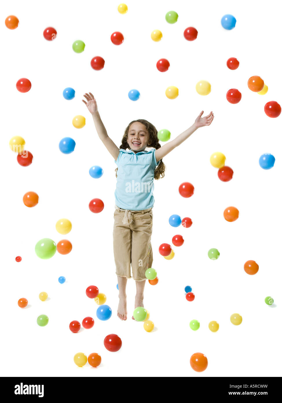 A girl smiling and playing with colored balls Stock Photo - Alamy