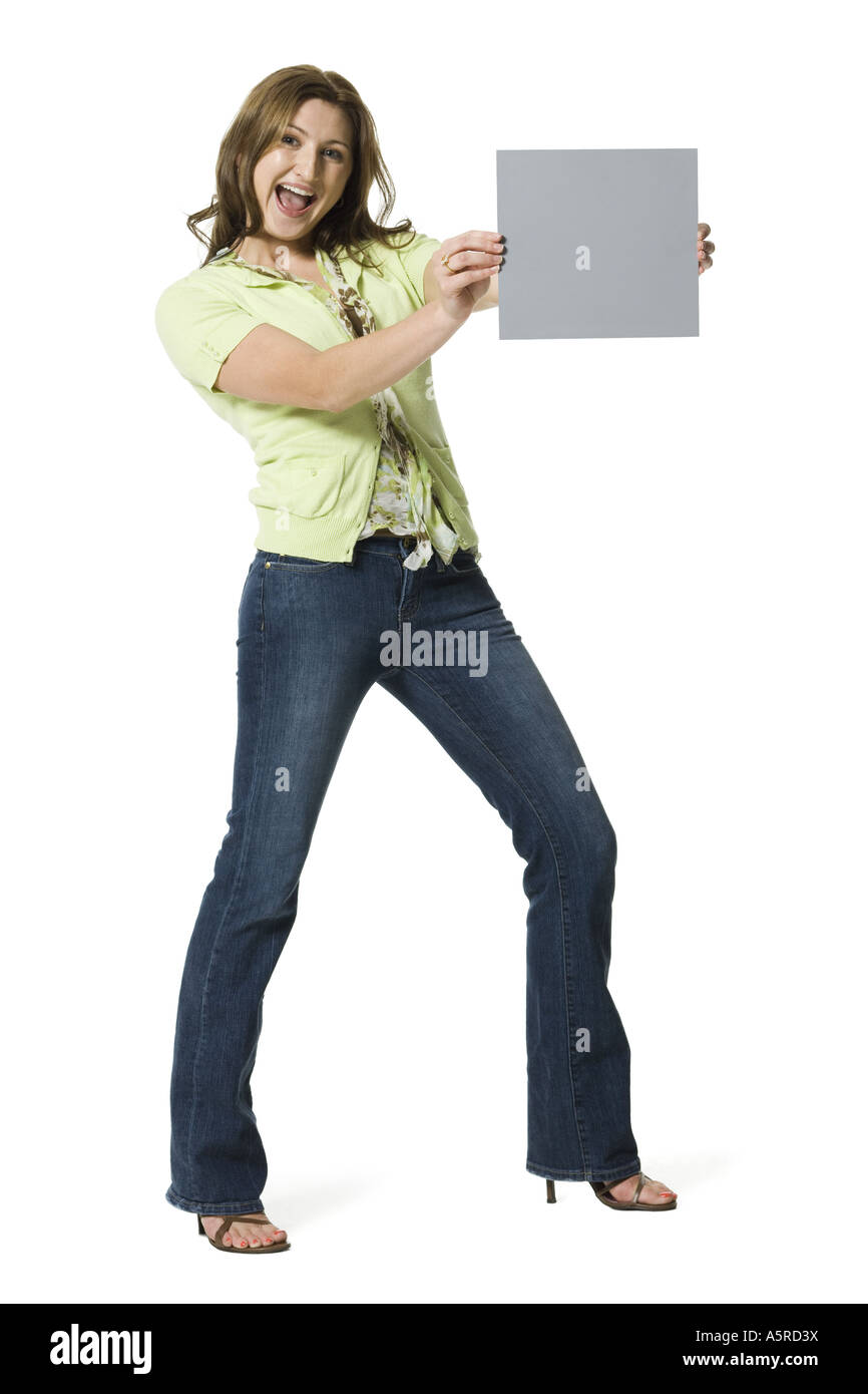 Portrait of a young woman standing and holding a blank sign Stock Photo ...