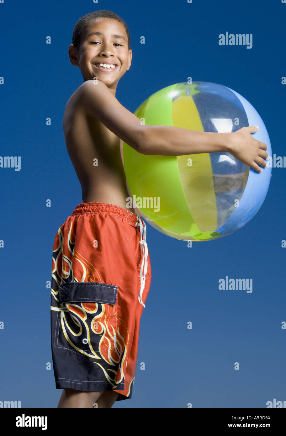 Portrait of a boy holding a beach ball Stock Photo - Alamy