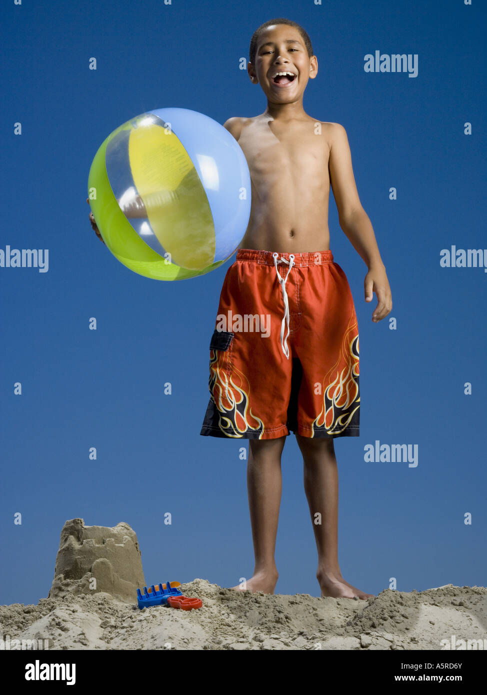 Portrait of a boy holding a beach ball hi-res stock photography and ...