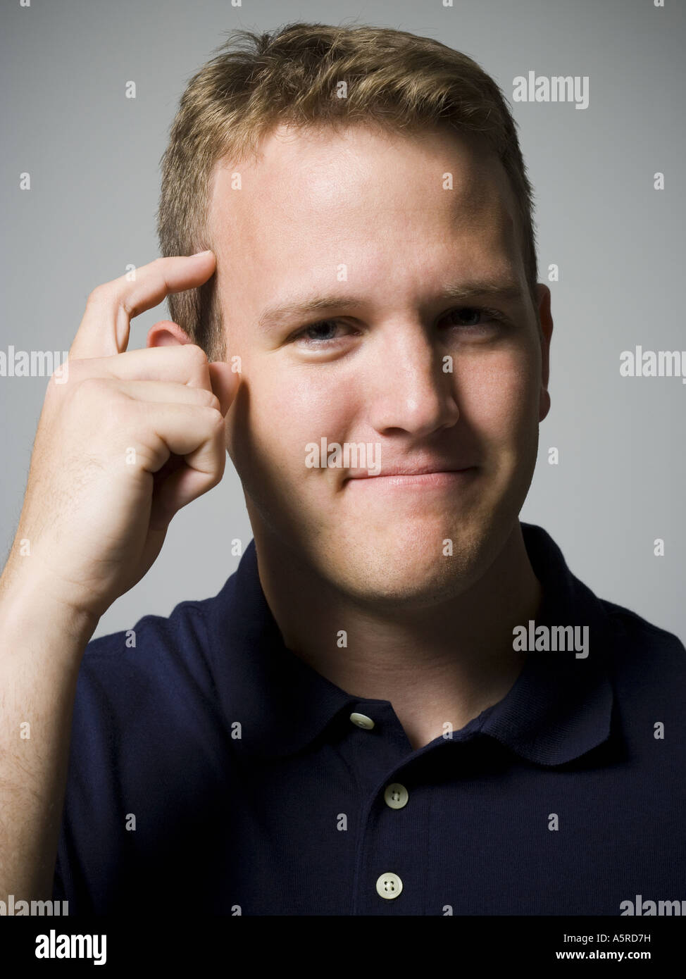 Portrait of a young man thinking Stock Photo - Alamy