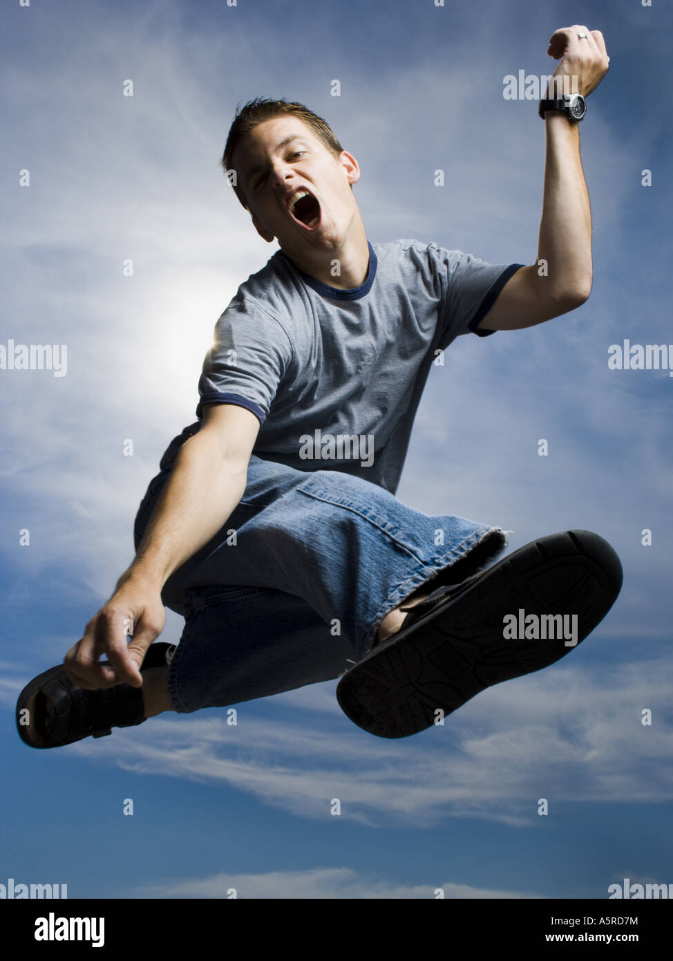 Low angle view of a young man jumping Stock Photo - Alamy