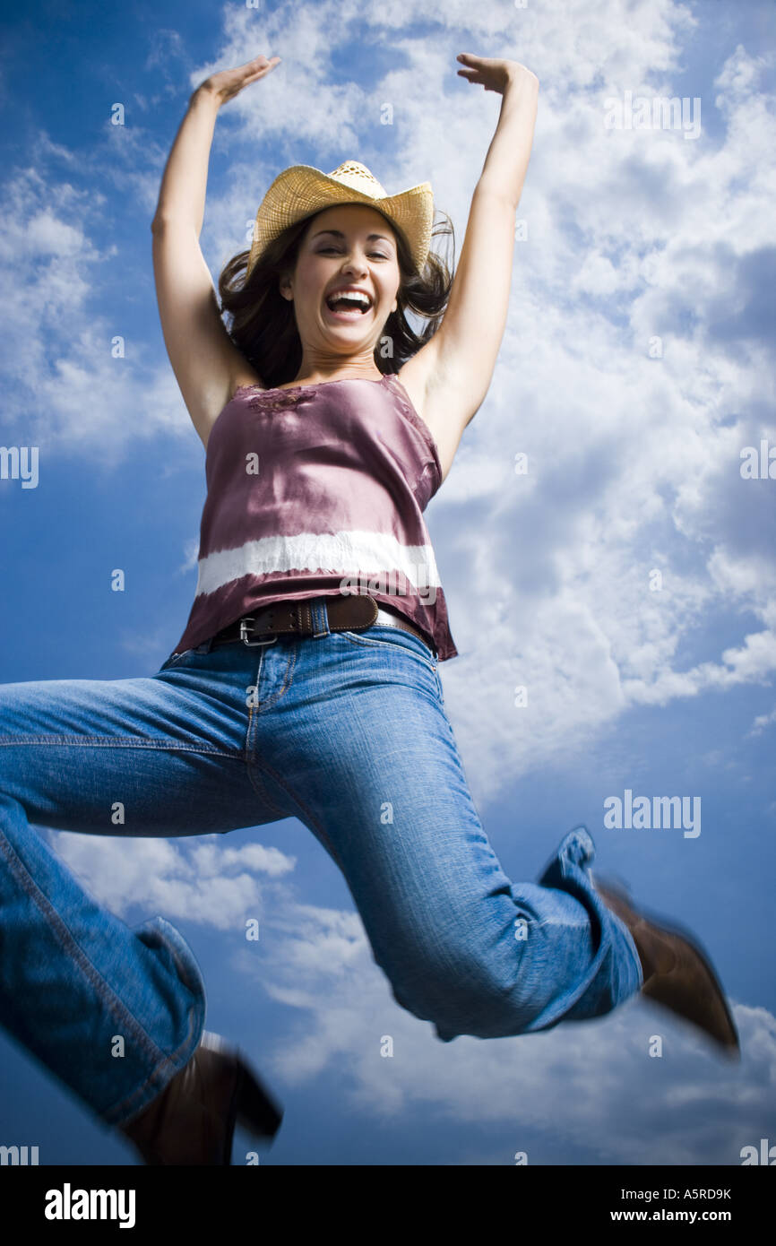 Low angle view of a young woman jumping Stock Photo - Alamy