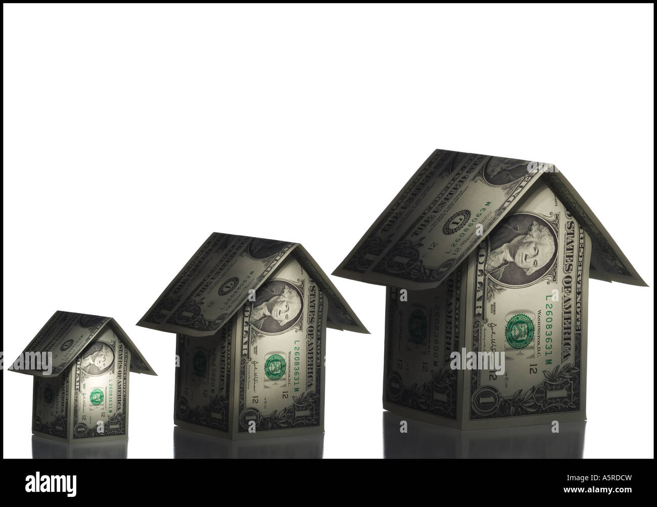 Three homes made of American paper currency Stock Photo - Alamy