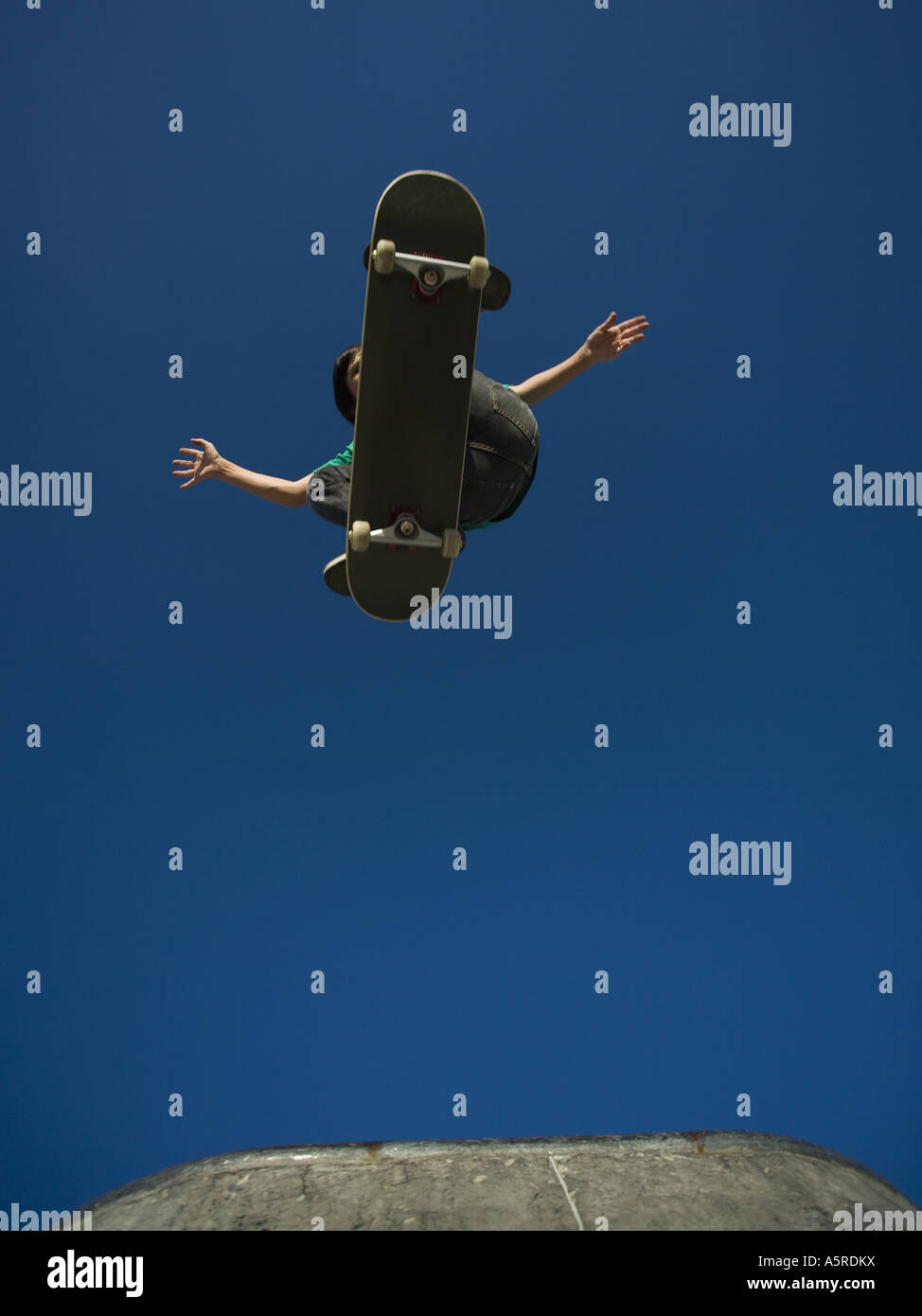 Low angle view of a person jumping with a skateboard Stock Photo - Alamy