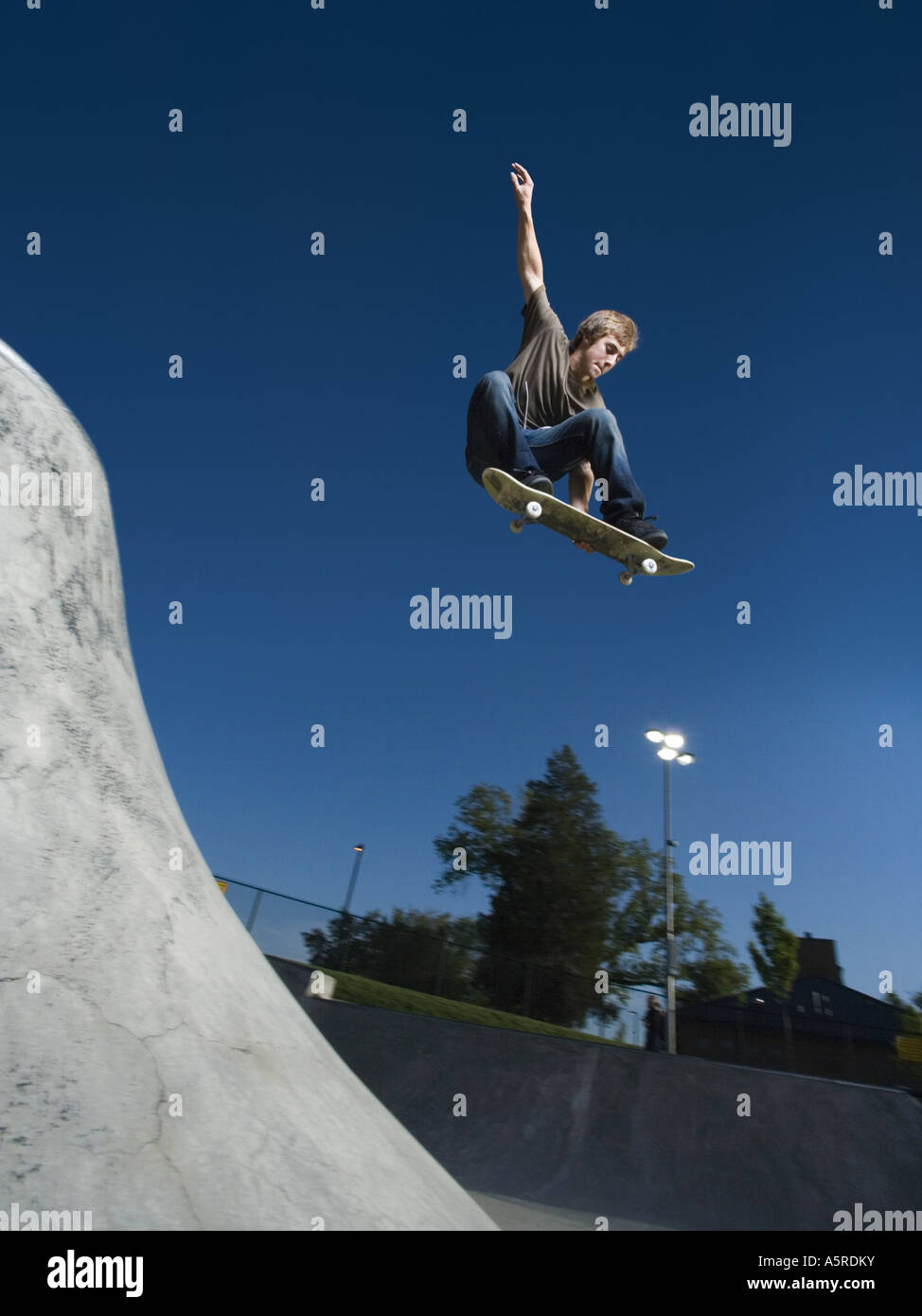 Low angle view of a teenage boy jumping with a skateboard Stock Photo ...