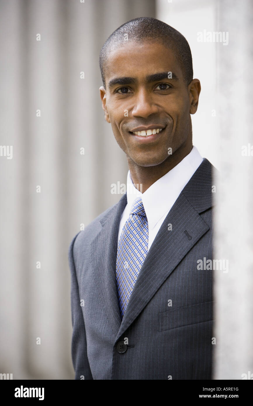 Portrait of a male lawyer standing in front of a courthouse and smiling ...