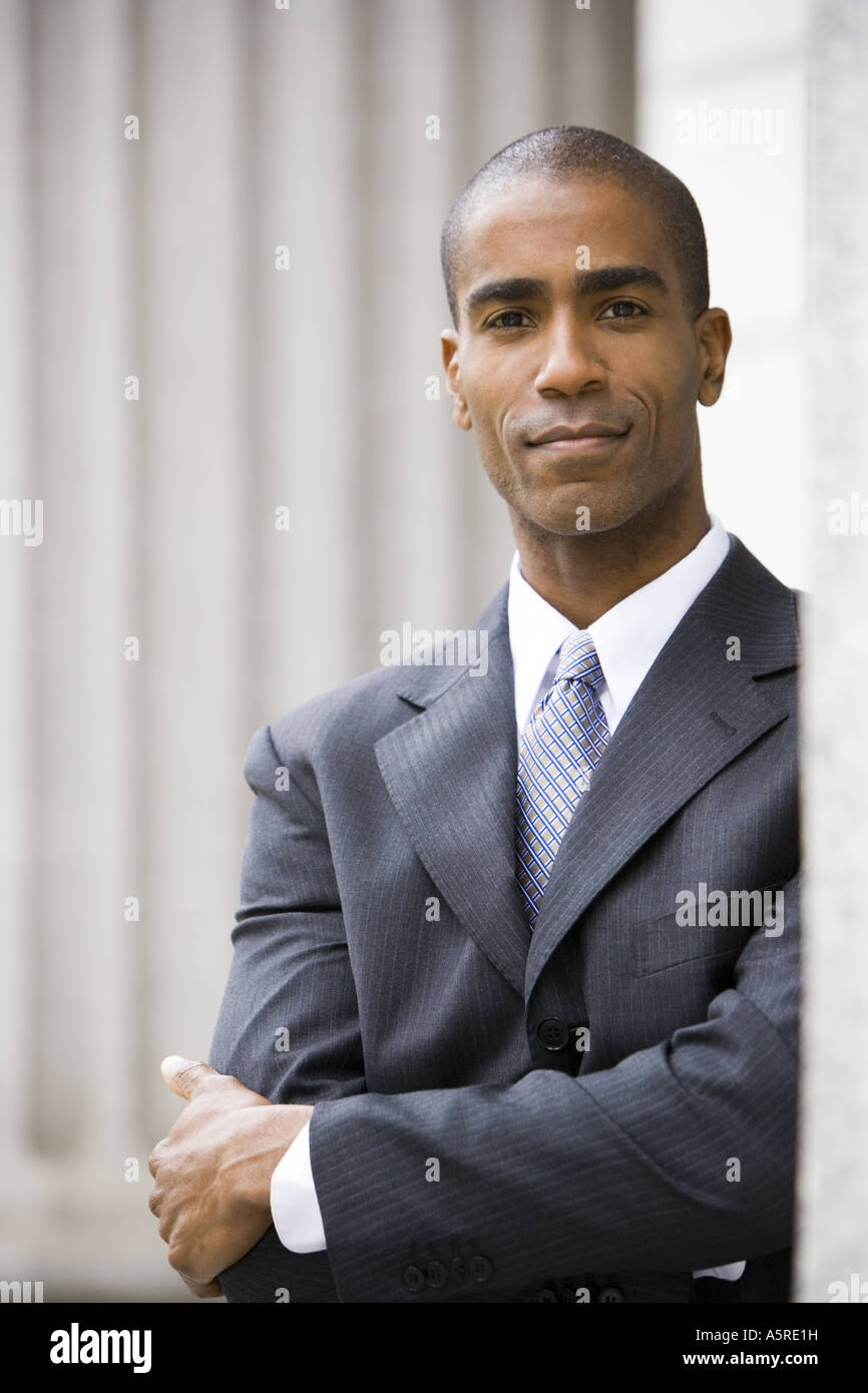 Portrait of a male lawyer standing with his arms folded Stock Photo - Alamy