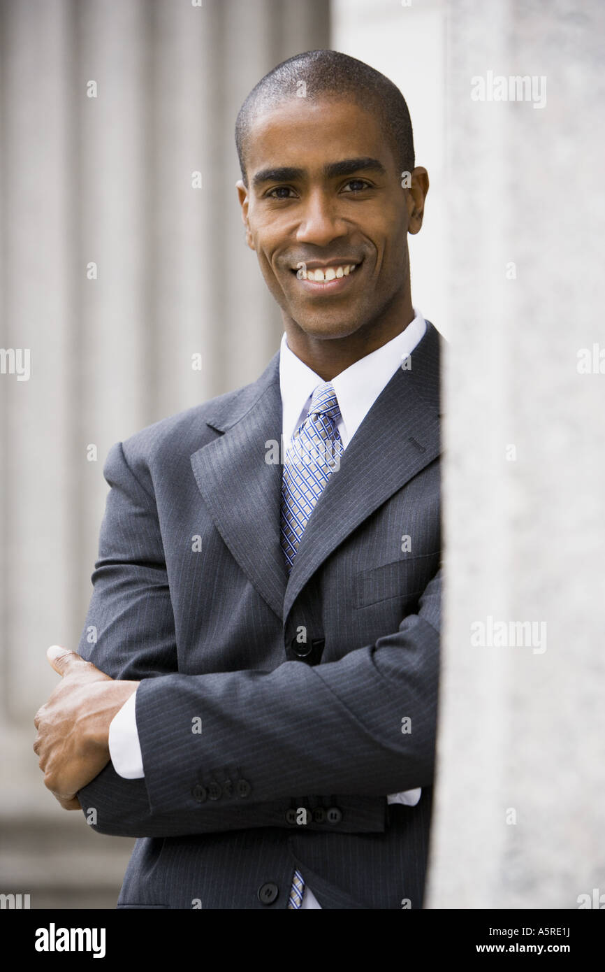 Portrait of a male lawyer standing with his arms folded Stock Photo - Alamy