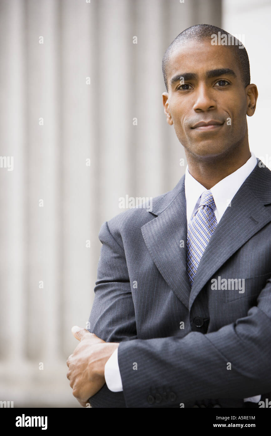 Portrait of a male lawyer standing with his arms folded Stock Photo - Alamy