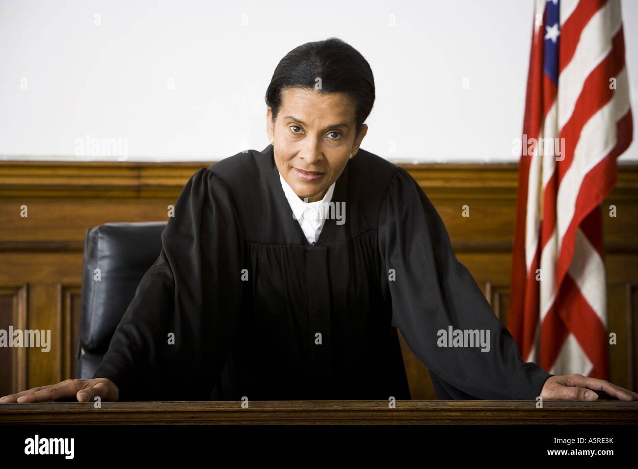 Portrait of a female judge leaning against a bench Stock Photo - Alamy
