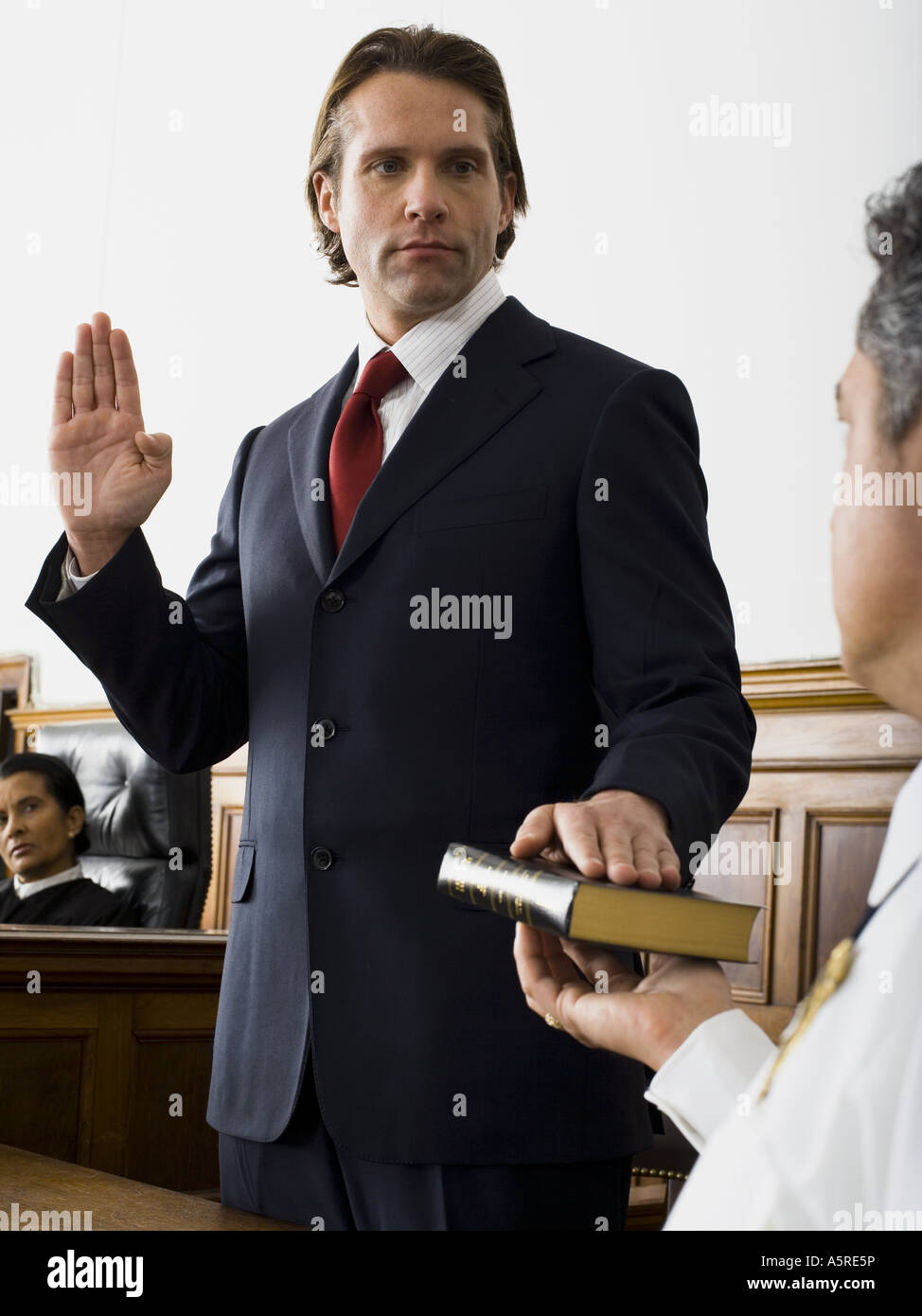 Witness swearing over the Bible Stock Photo - Alamy