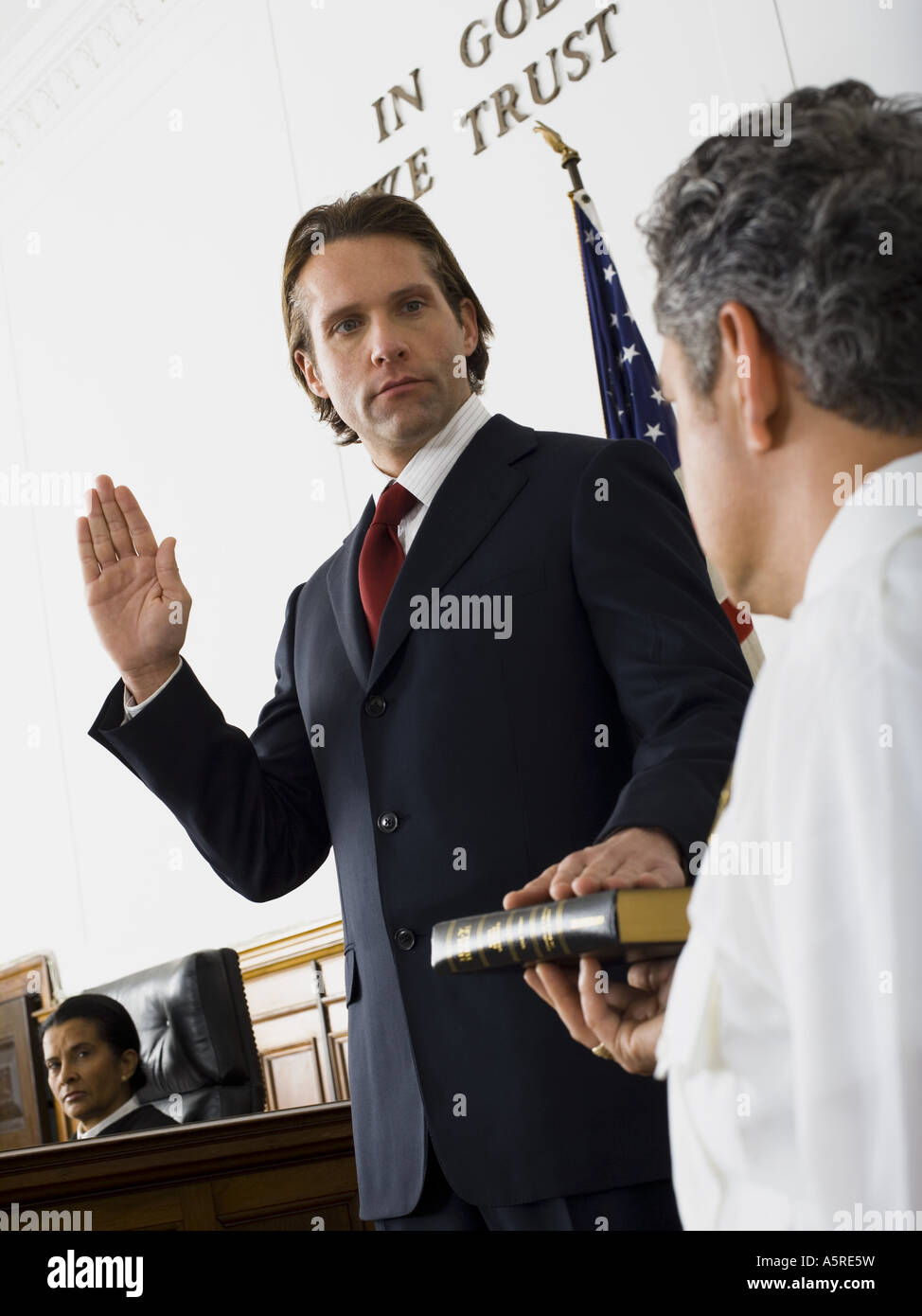Witness swearing over the Bible Stock Photo - Alamy