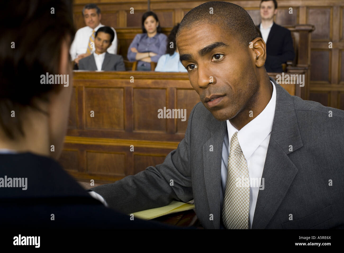 A male lawyer looking at another lawyer in a courtroom Stock Photo - Alamy