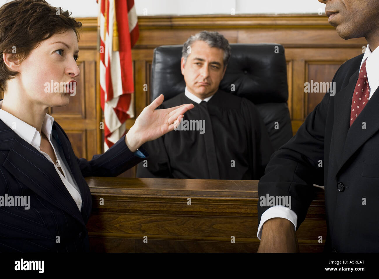 Two lawyers standing face to face in front of a male judge in a ...