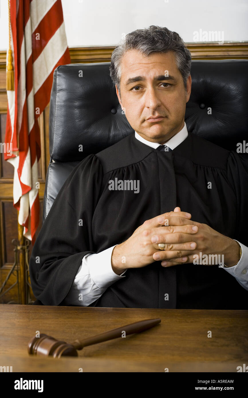 Portrait of a male judge sitting with his hands clasped Stock Photo - Alamy